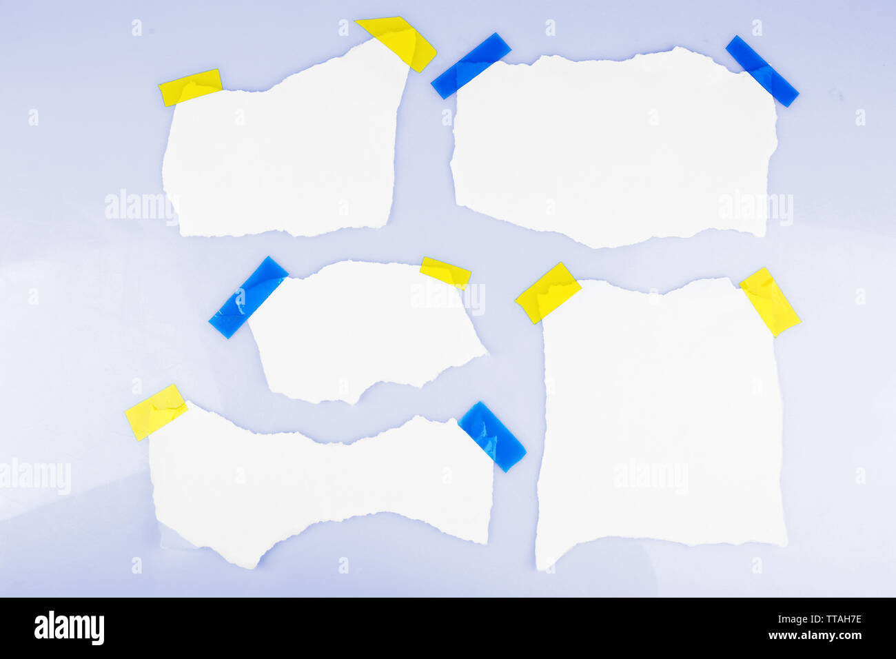 White pieces of paper attached on white background Stock Photo - Alamy
