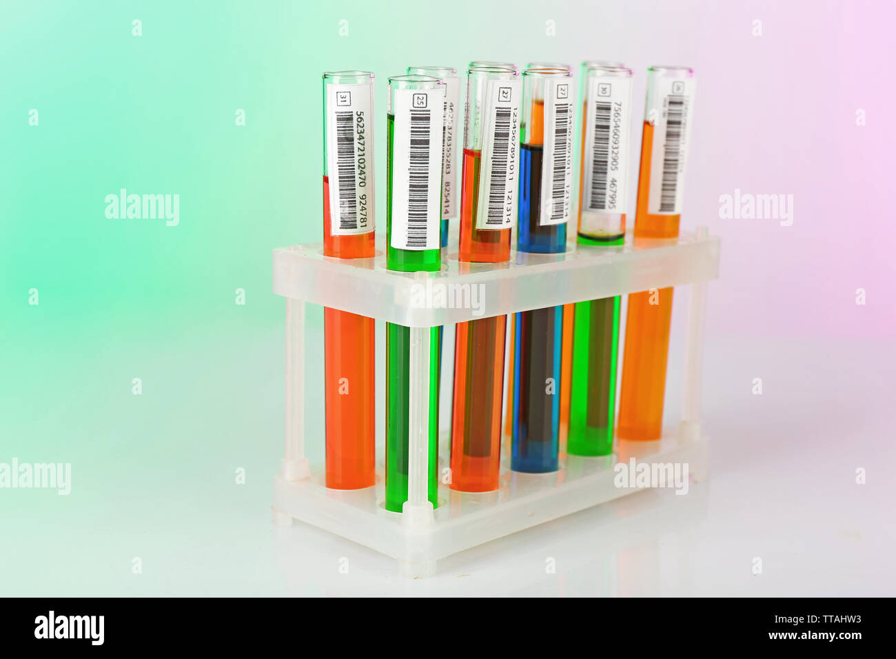 Test tubes with colorful liquid on light color background Stock Photo ...