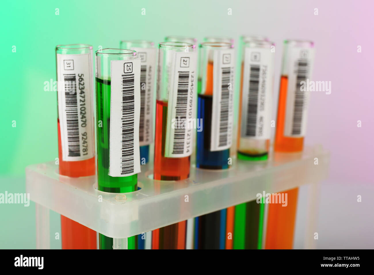Test tubes with colorful liquid on light color background Stock Photo ...