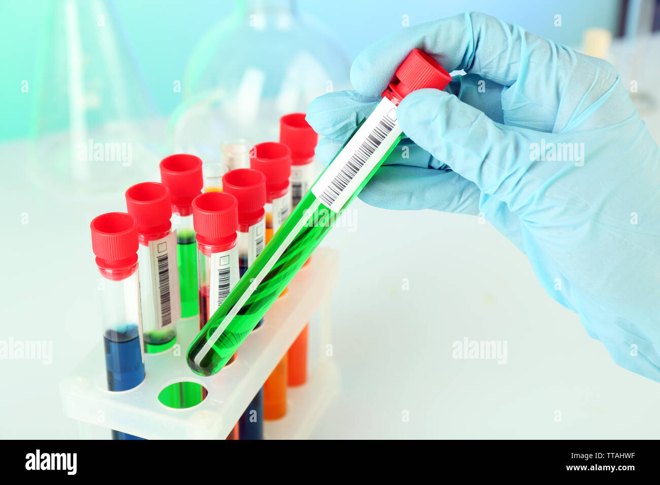 Test tubes with colorful liquid in scientist hand, closeup Stock Photo ...