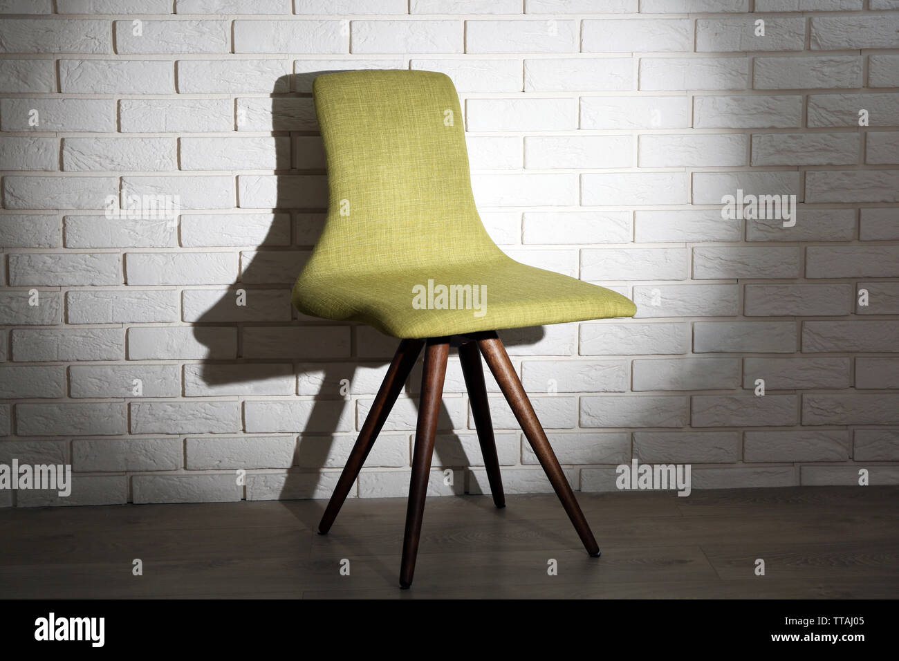 Modern chair on brick wall background Stock Photo - Alamy