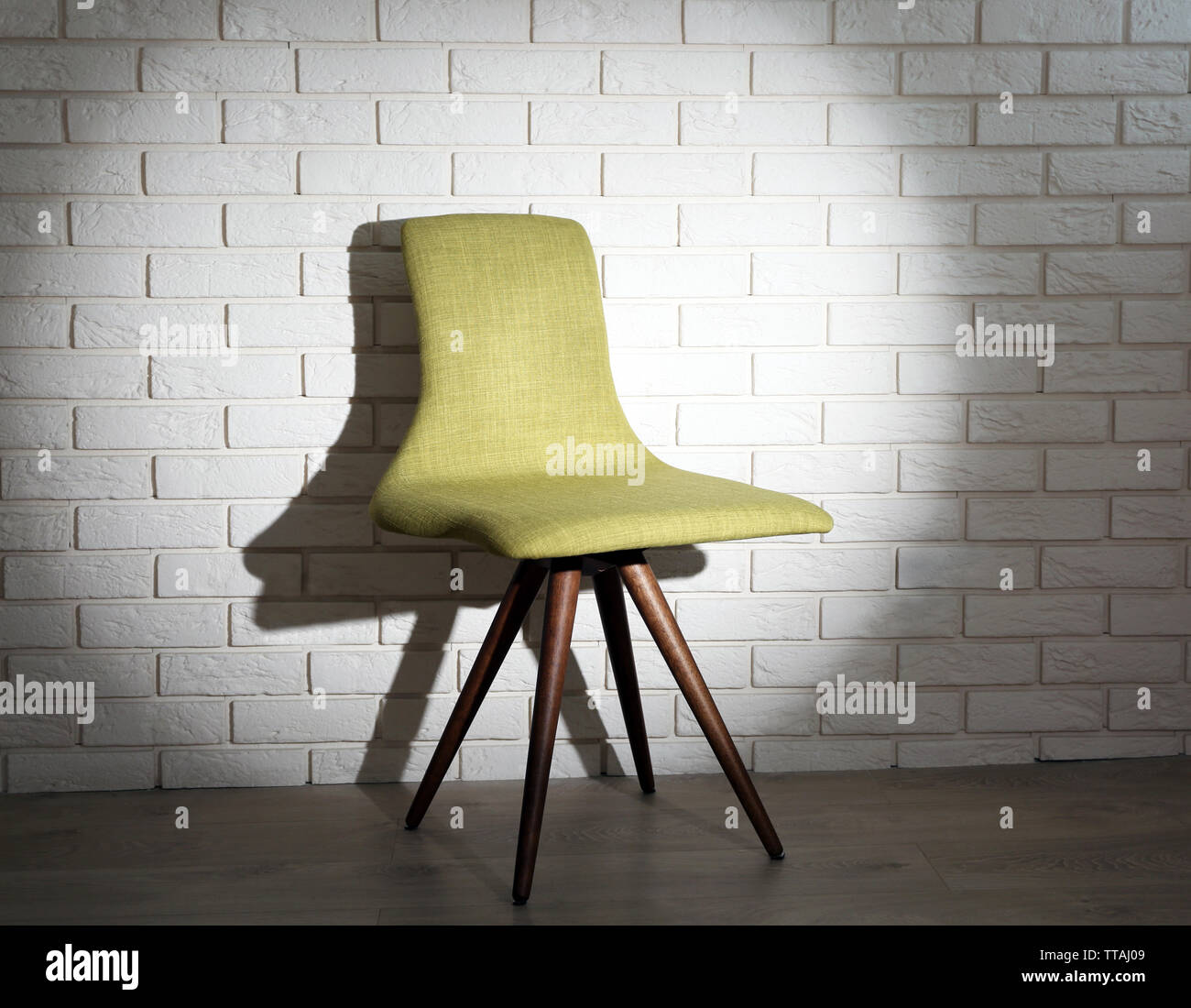 Modern chair on brick wall background Stock Photo - Alamy