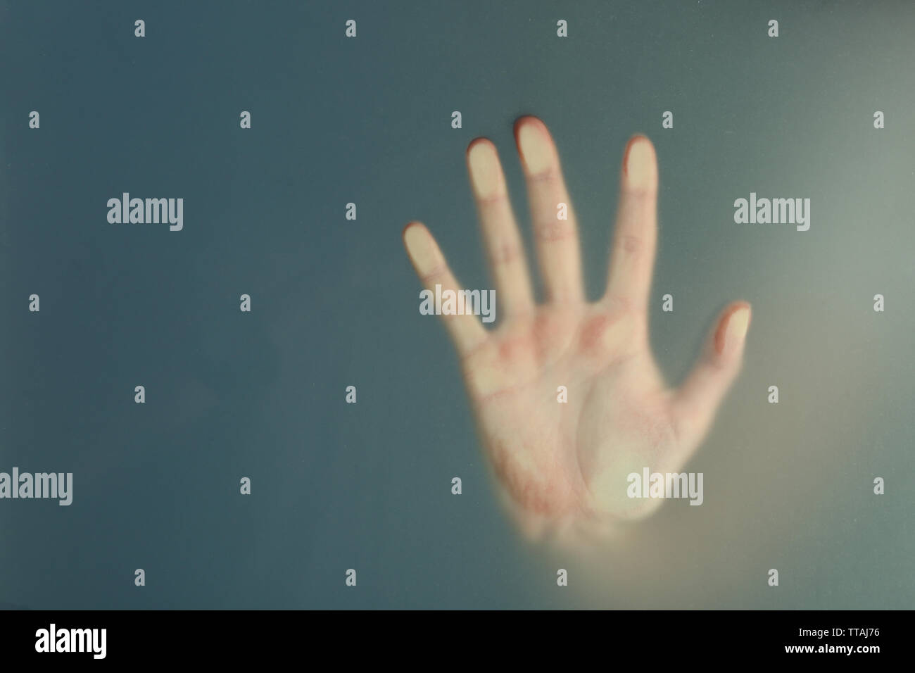 Female hand behind wet glass, close-up Stock Photo - Alamy