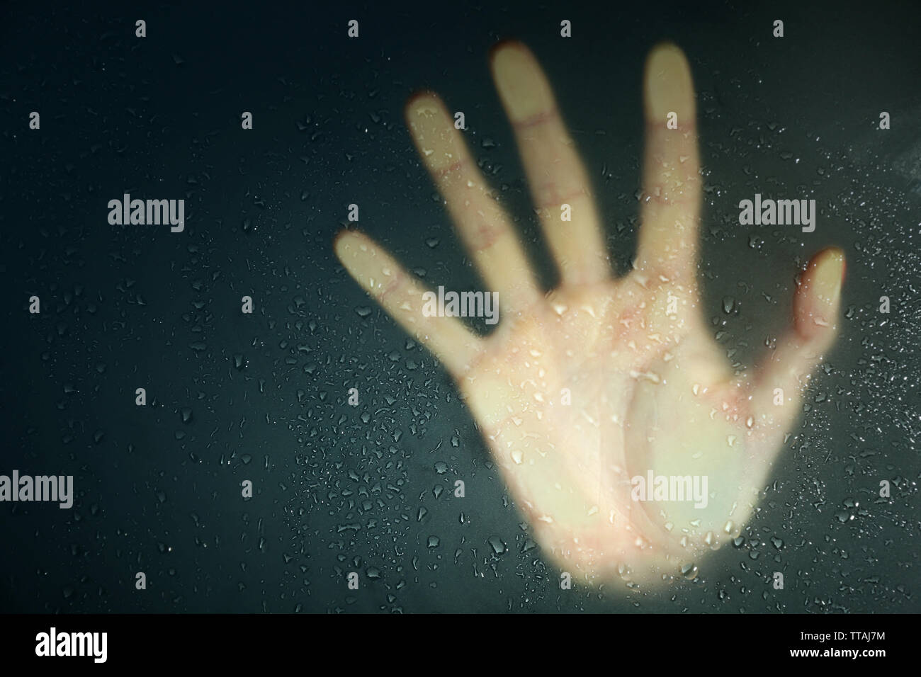 Female hand behind wet glass, close-up Stock Photo - Alamy