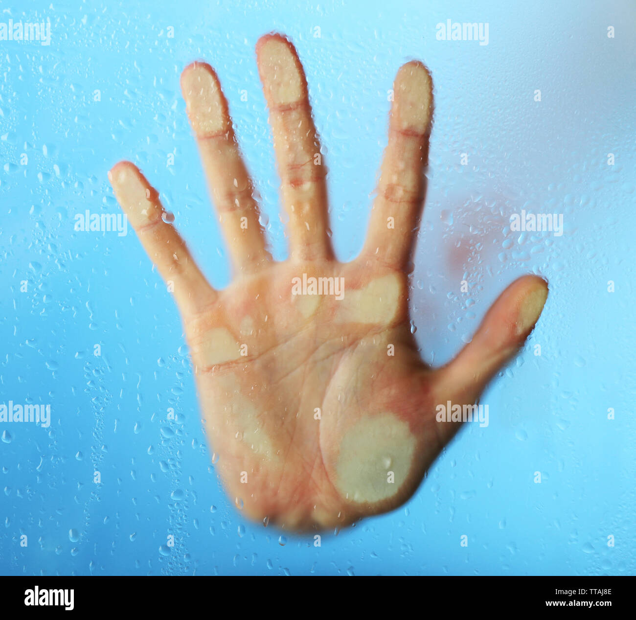 Female hand behind wet glass, close-up Stock Photo - Alamy