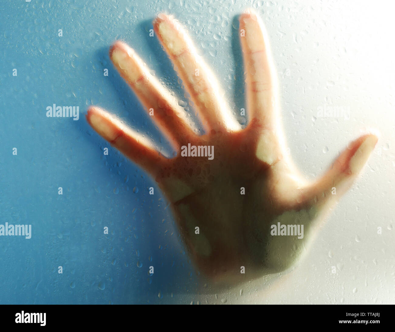 Female hand behind wet glass, close-up Stock Photo - Alamy