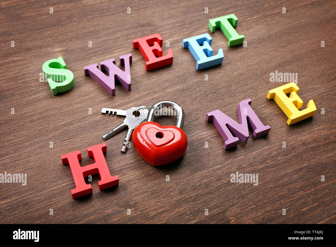 Decorative letters forming words SWEET HOME with lock and keys on ...