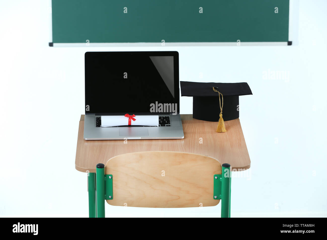 School desk with laptop, master hat and diploma in classroom Stock ...