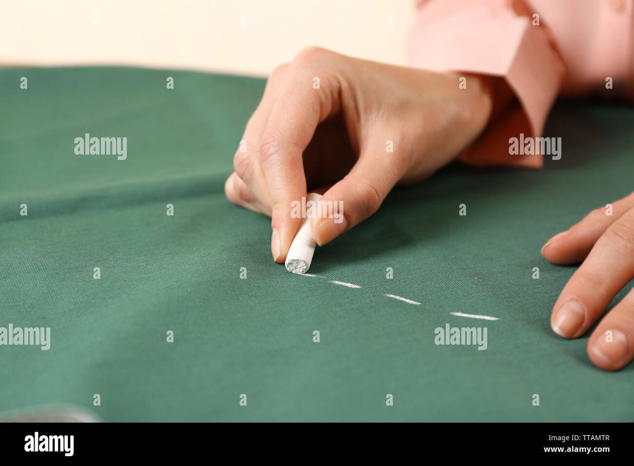 Closeup hands of seamstress at work with cloth fabric Stock Photo - Alamy