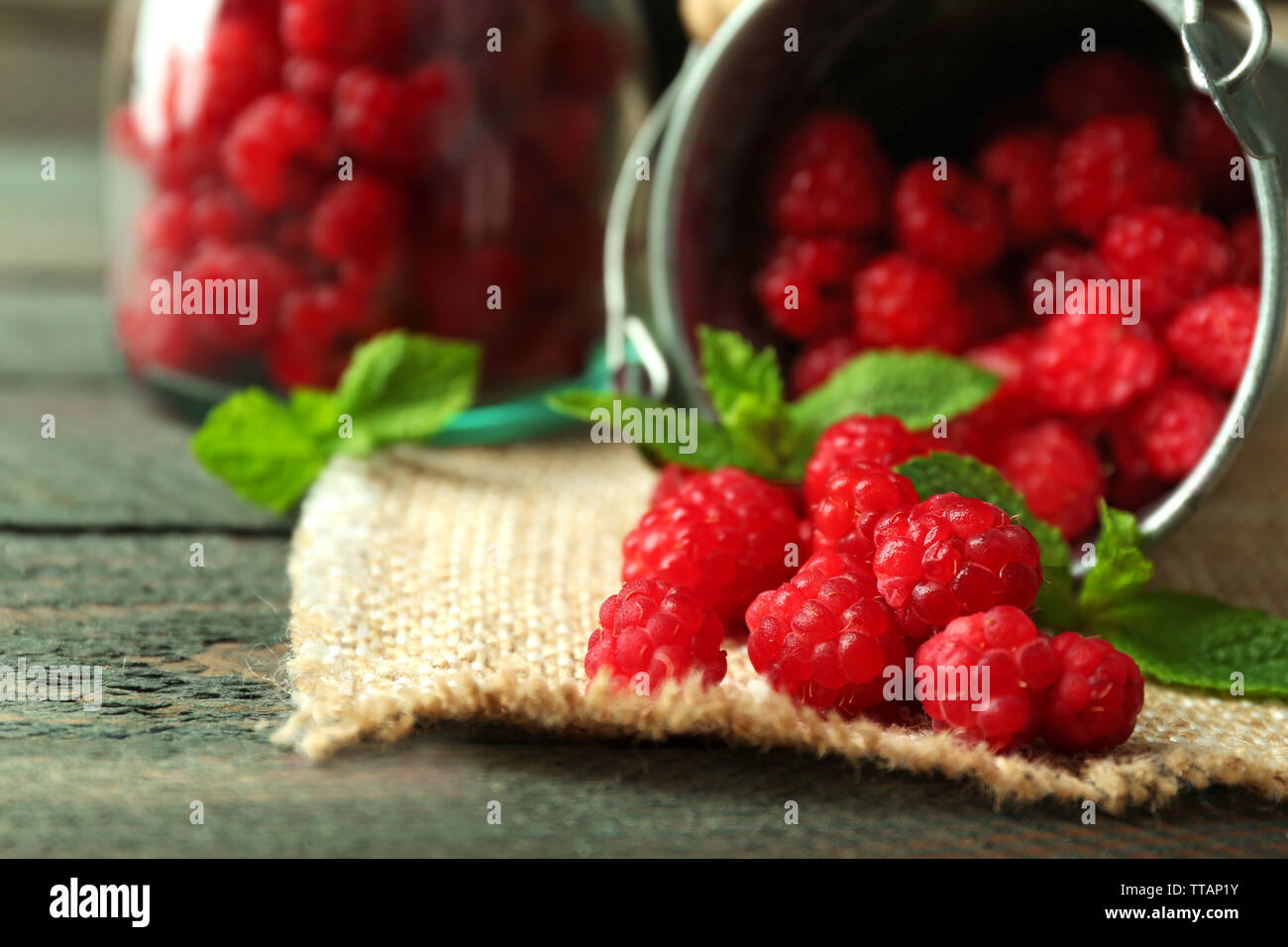 Sweet raspberries in decorative bucket on wooden background Stock Photo ...