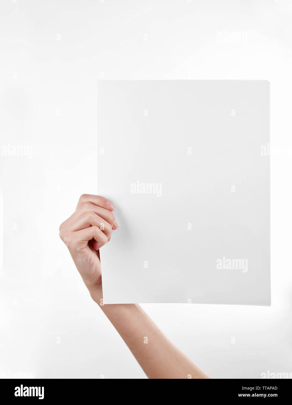 Female hand holding paper blank isolated on white Stock Photo - Alamy