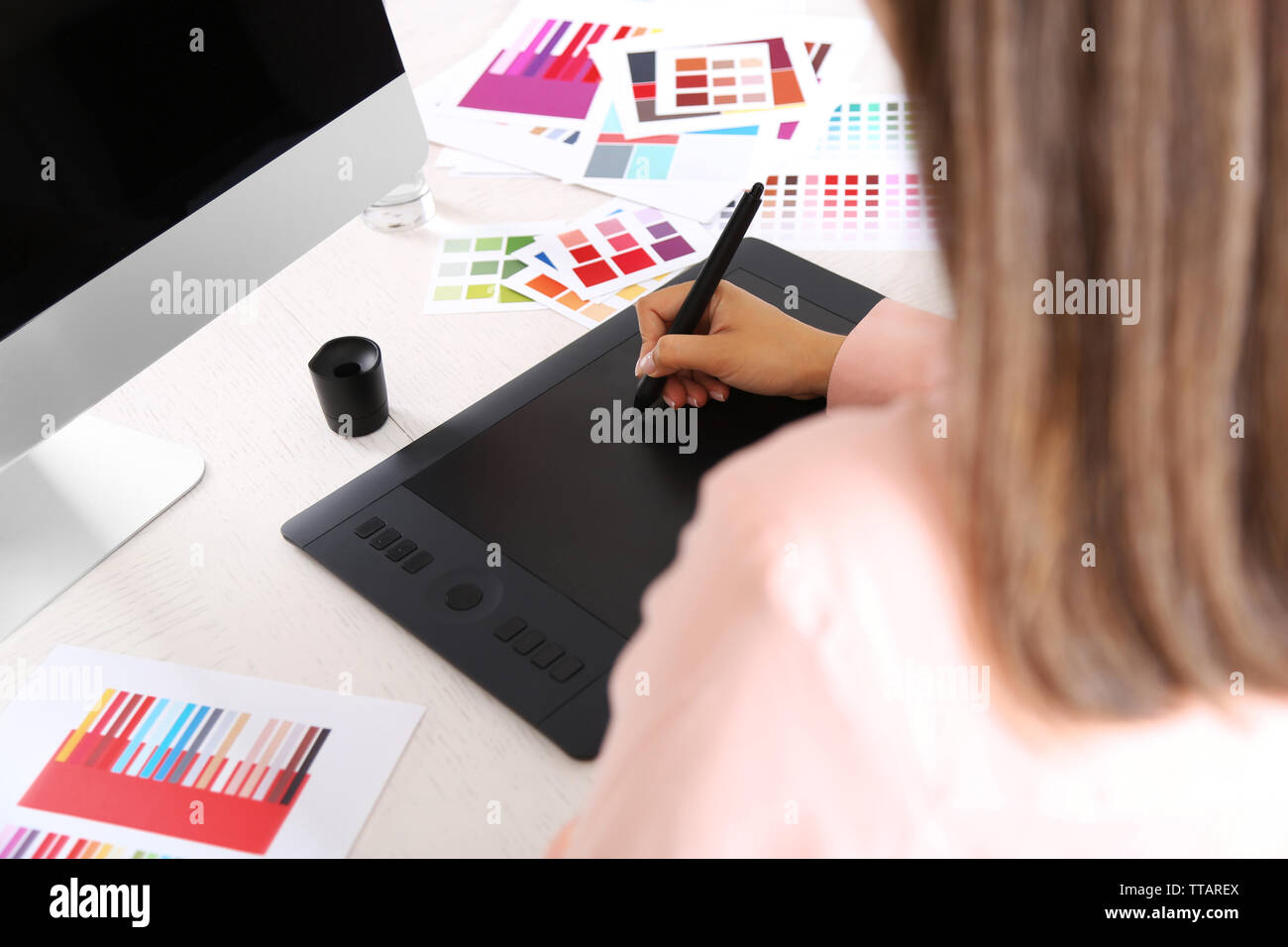 Artist drawing on graphic tablet in office Stock Photo - Alamy