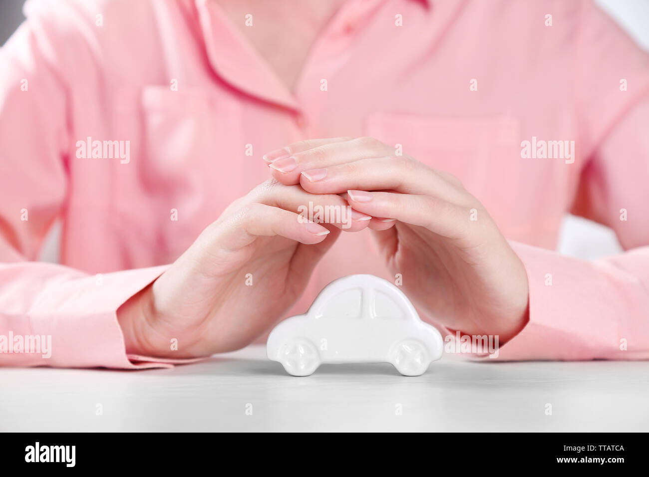 Hands and toy car. Protection of car concept Stock Photo - Alamy