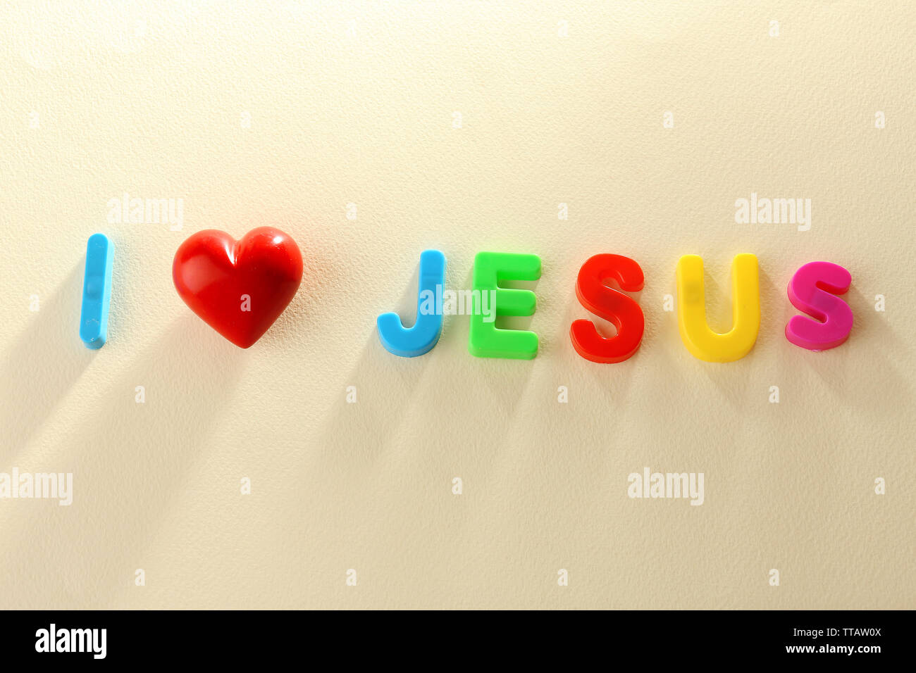 I LOVE JESUS sign illustrated with colorful plastic letters on light ...