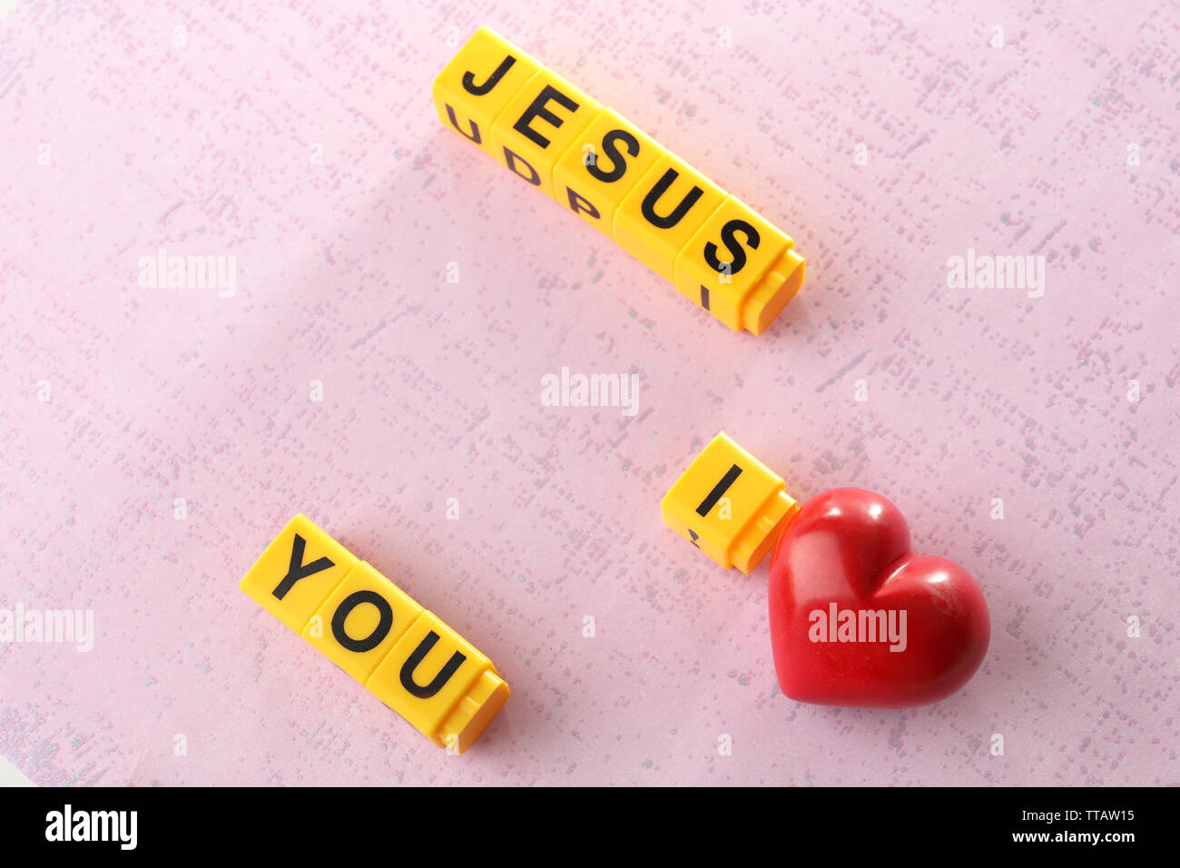I LOVE JESUS sign illustrated with colorful plastic letters on pink ...