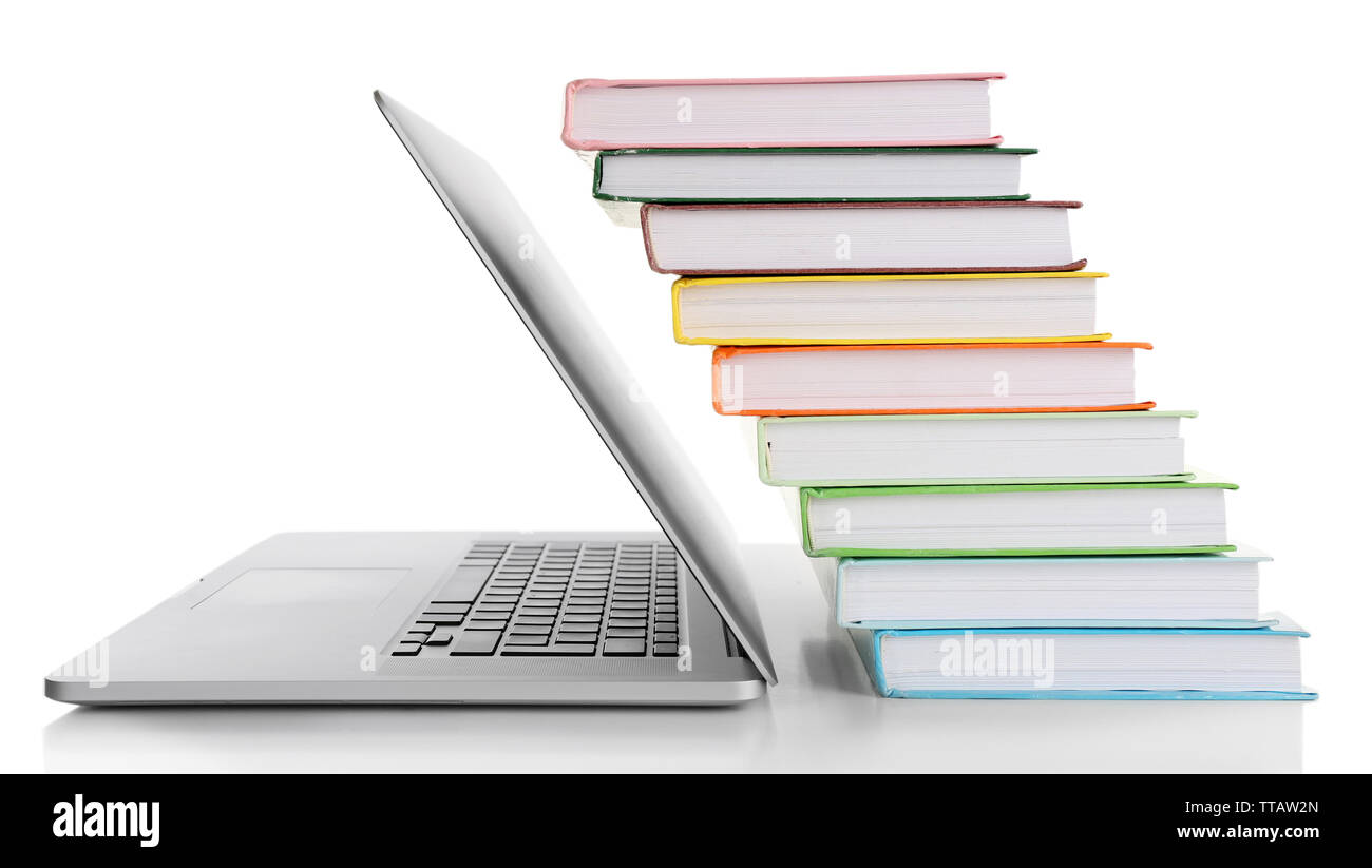 Stack of books with laptop isolated on white Stock Photo - Alamy