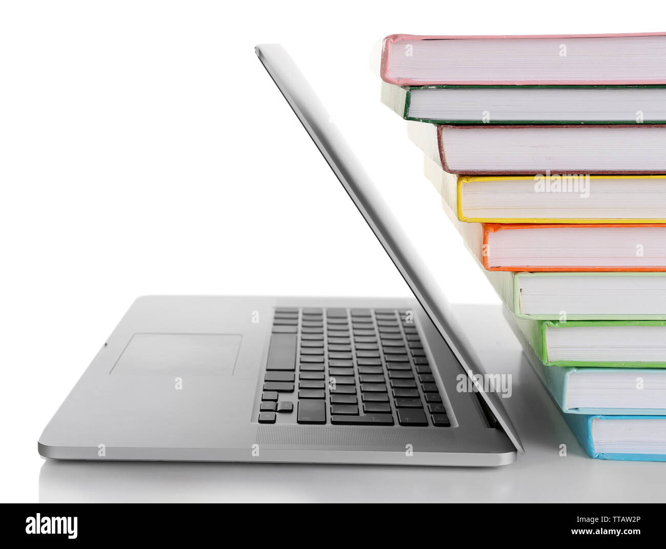 Stack of books with laptop isolated on white Stock Photo - Alamy