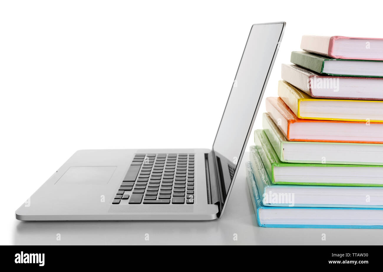Stack of books with laptop isolated on white Stock Photo - Alamy