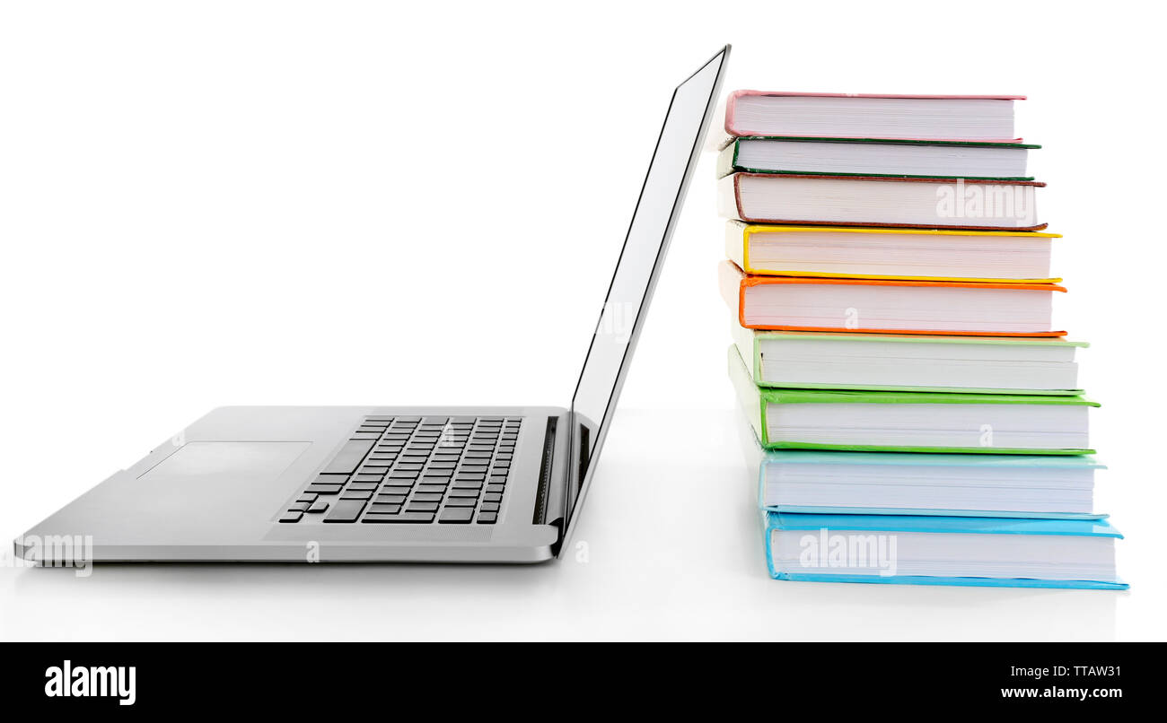 Stack of books with laptop isolated on white Stock Photo - Alamy
