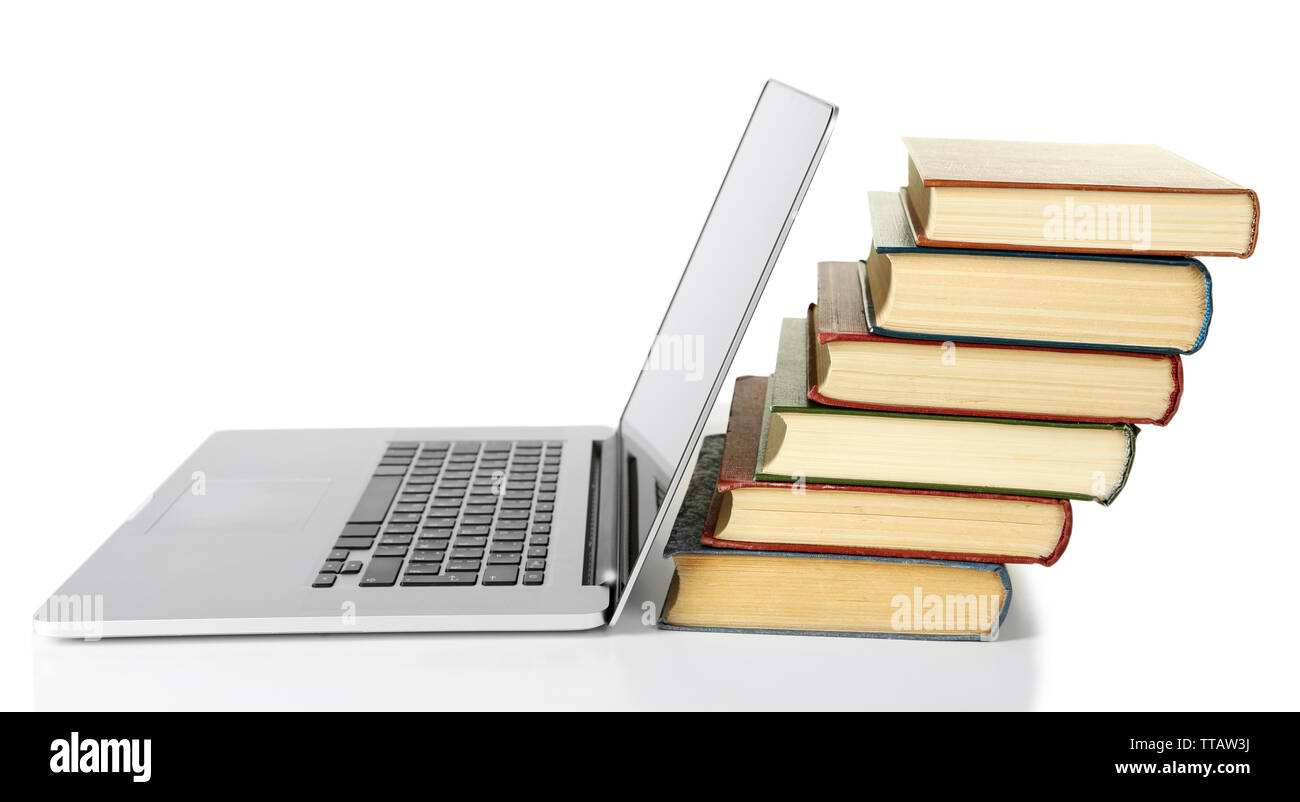 Stack of books with laptop isolated on white Stock Photo - Alamy