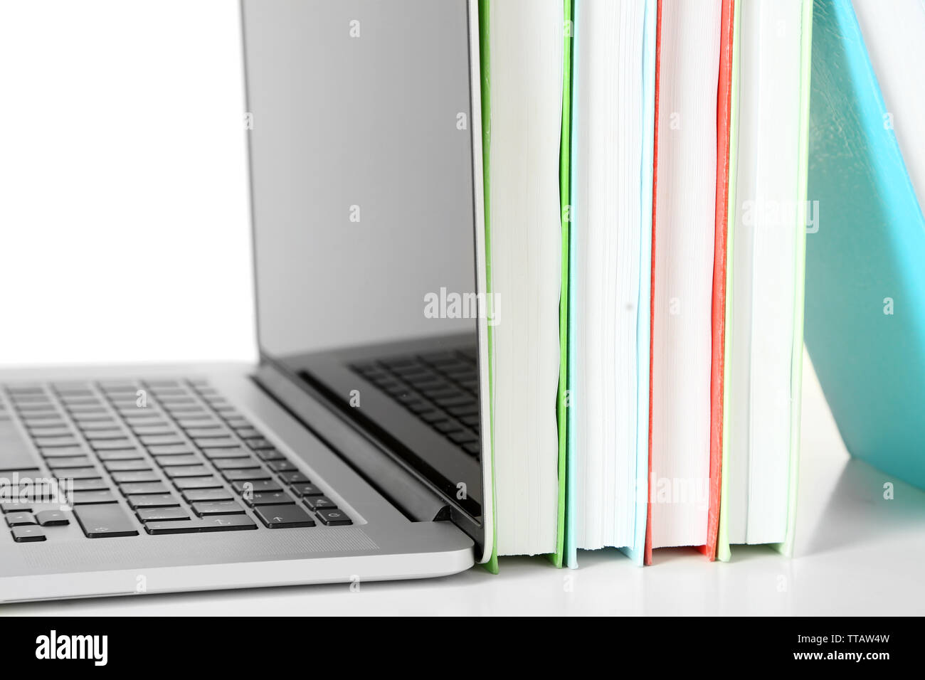 Stack of books with laptop close up Stock Photo - Alamy