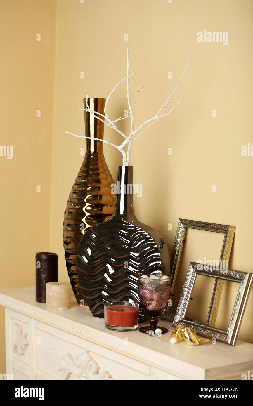 Modern vases with decor on fireplace in room Stock Photo - Alamy