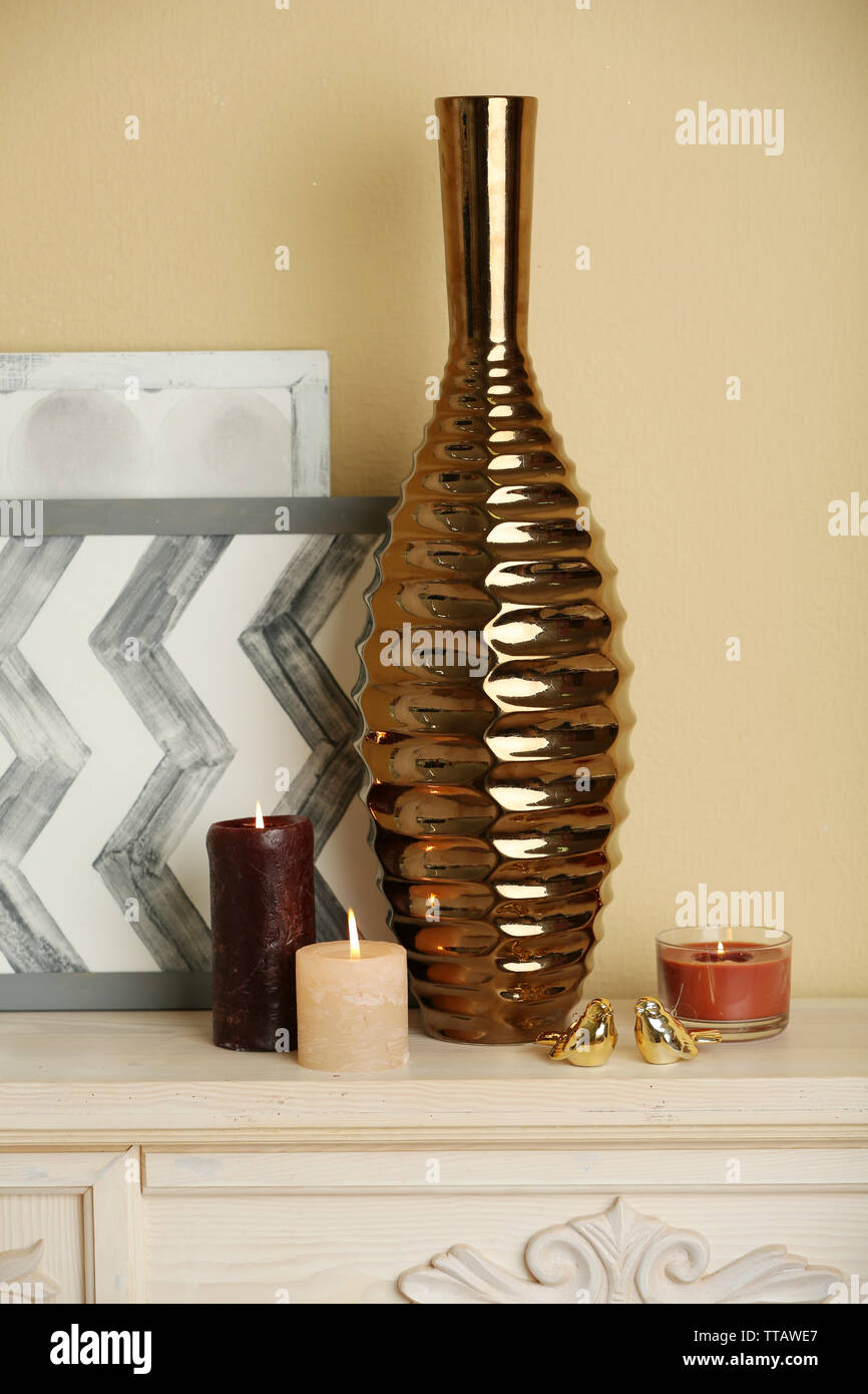 Modern vase with decor on fireplace in room Stock Photo - Alamy