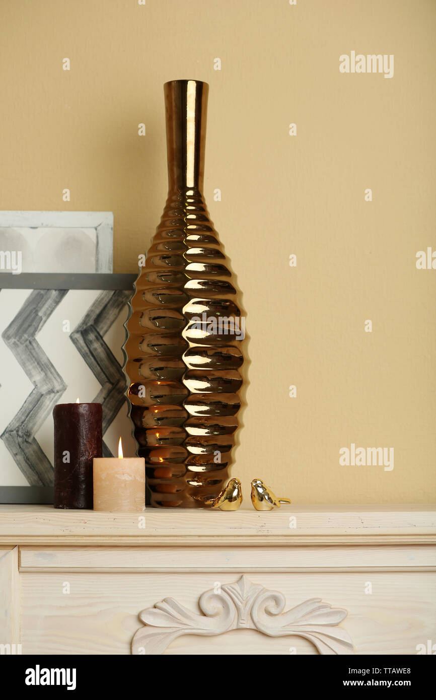 Modern vase with decor on fireplace in room Stock Photo - Alamy