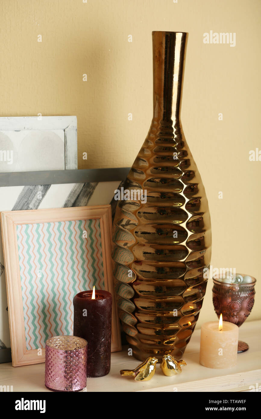 Modern vase with decor on fireplace in room Stock Photo - Alamy