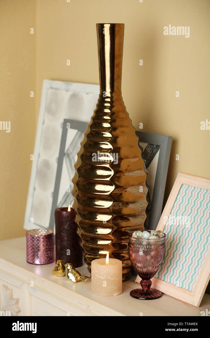 Modern vase with decor on fireplace in room Stock Photo - Alamy