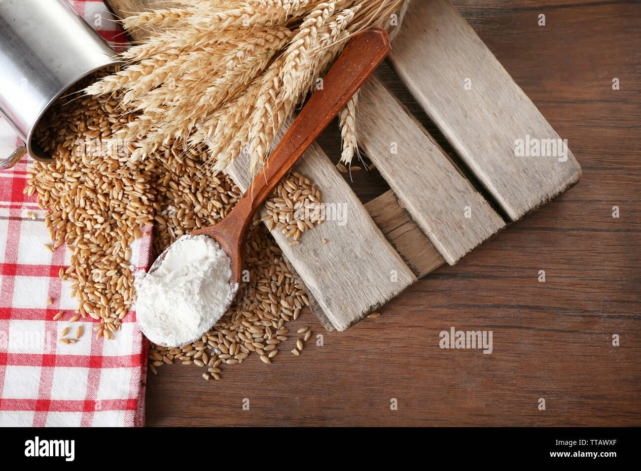 Flour and wheat on wooden table, top view Stock Photo - Alamy