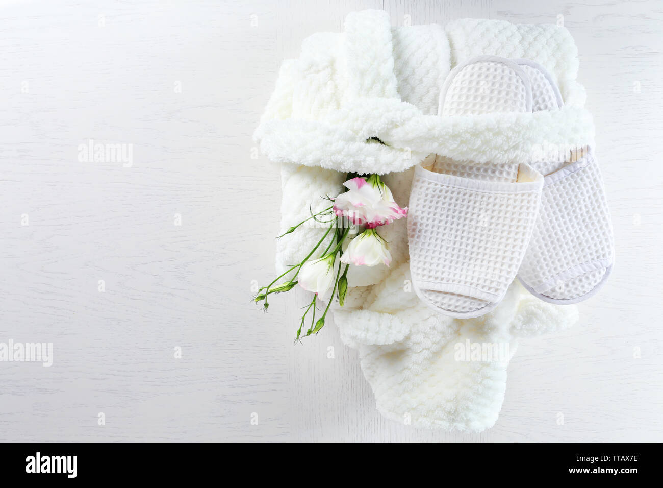 Bath set with white bathrobe and slippers, top view Stock Photo - Alamy