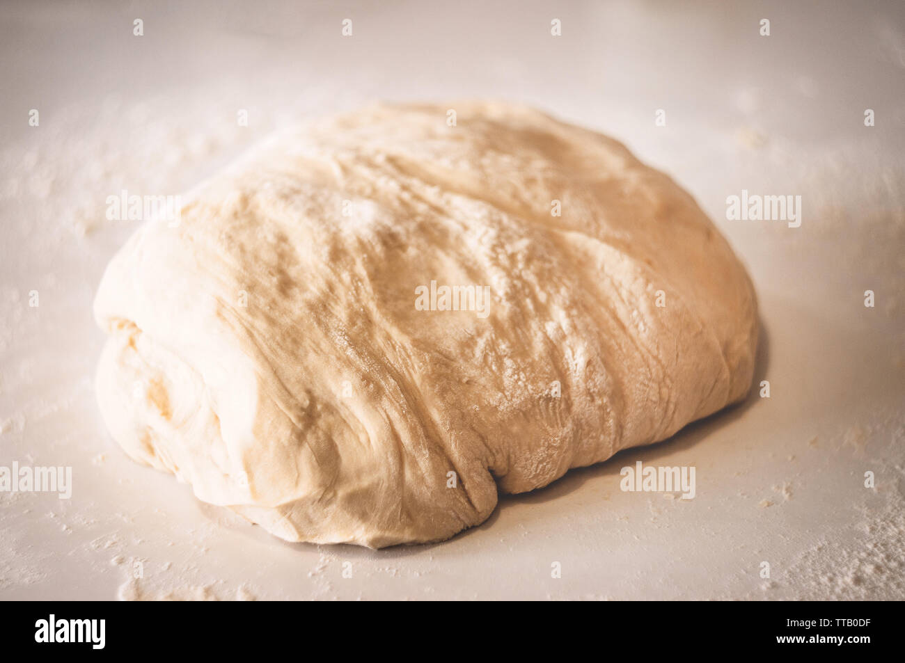 freshly prepared dough and dusting of flour on white background Stock ...