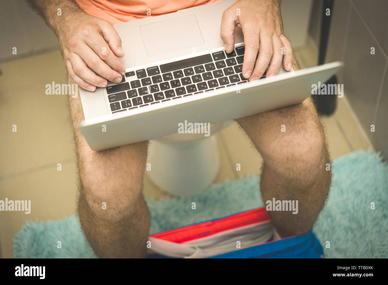 Businessman is working with laptop while sitting on the toilet Stock ...