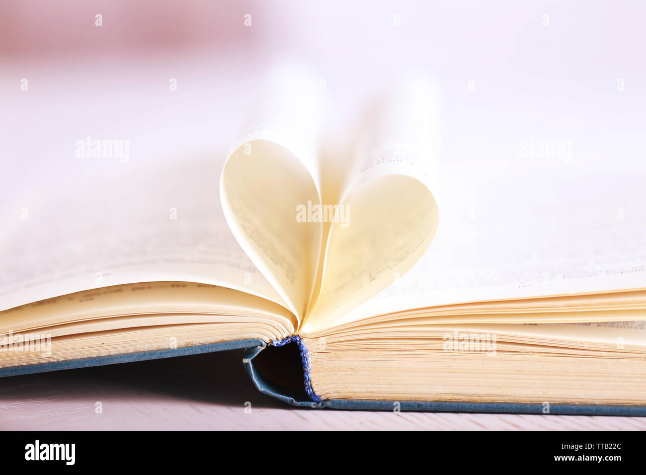 Pages of book curved into heart shape, close up Stock Photo - Alamy