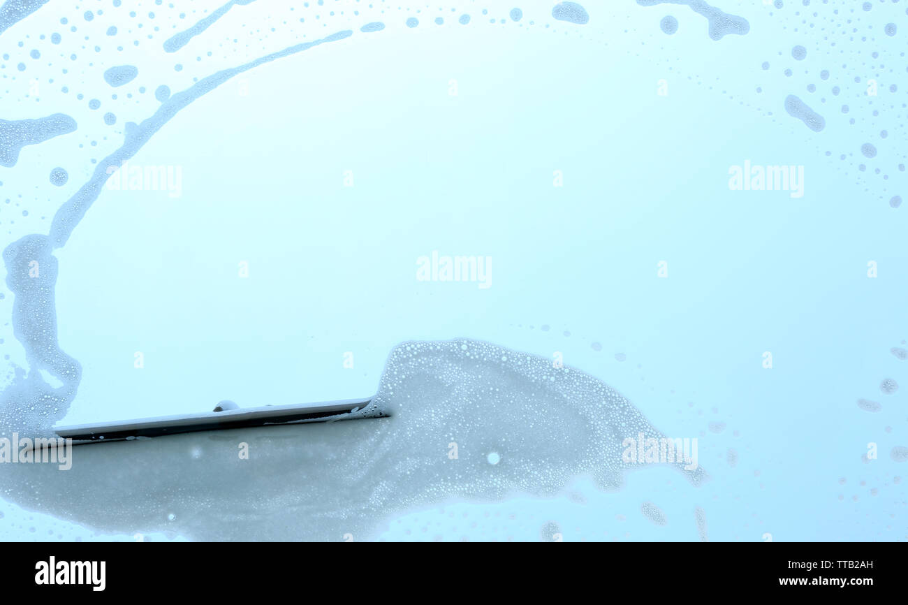 Washing window with soap and foam, closeup Stock Photo - Alamy