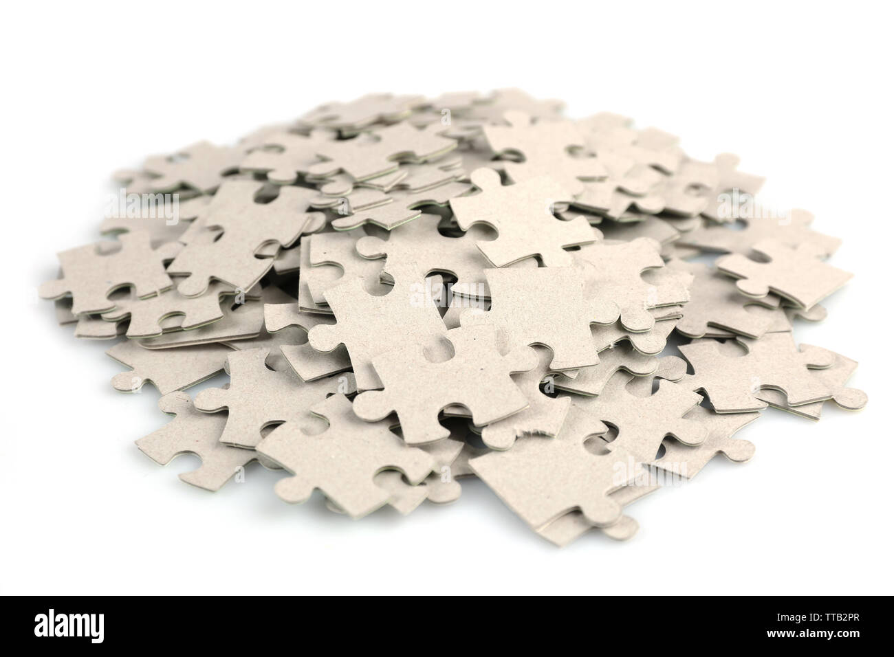 Pile of puzzle pieces isolated on white Stock Photo - Alamy