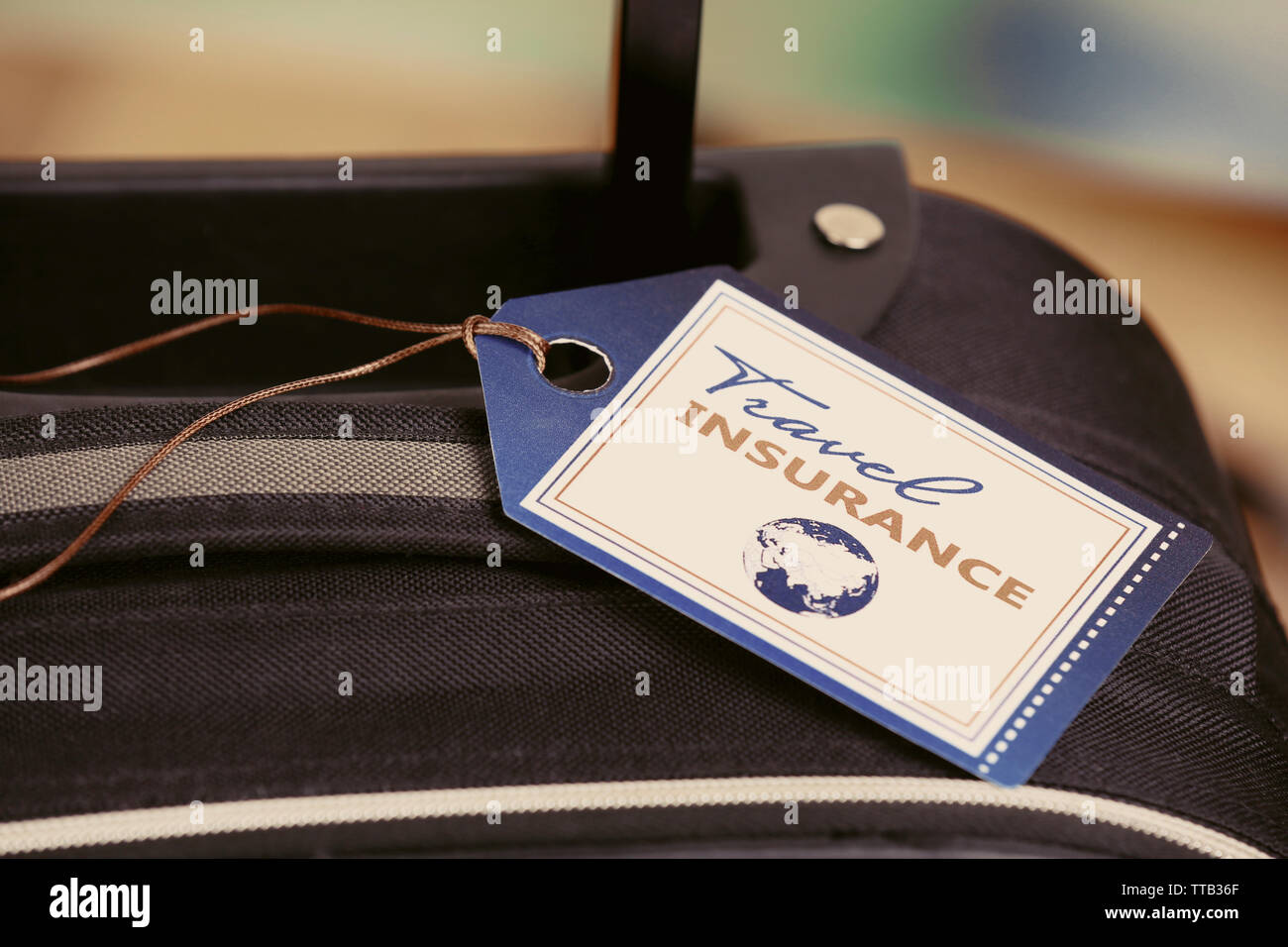 Suitcase with TRAVEL INSURANCE label, closeup Stock Photo - Alamy