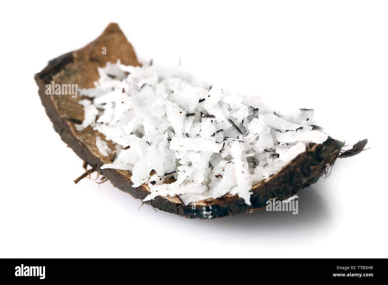 Coconut shavings in coconut shell on white background Stock Photo - Alamy