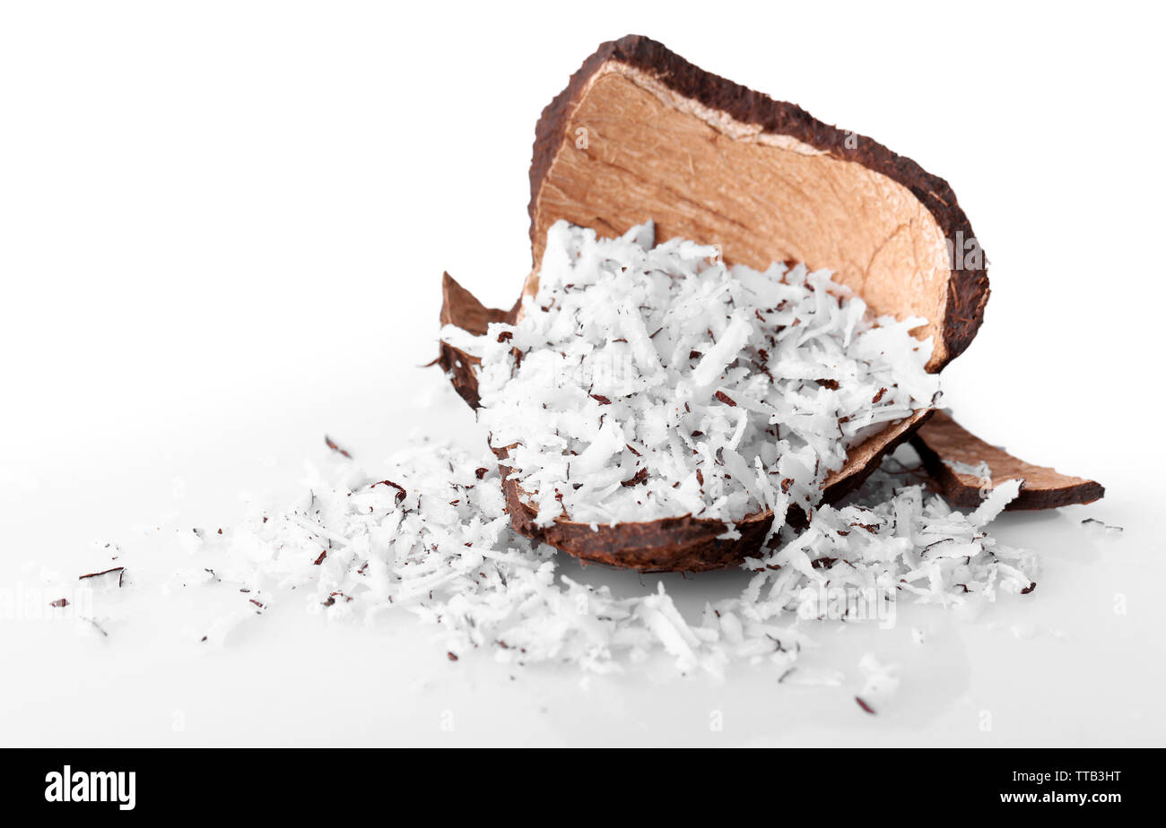 Coconut shavings in coconut shell on white background Stock Photo - Alamy