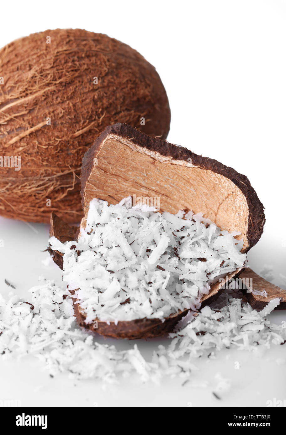 Coconut shavings in coconut shell on white background Stock Photo - Alamy