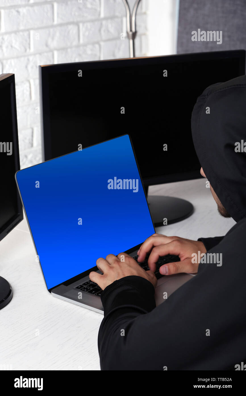 Hacker with laptop Stock Photo - Alamy