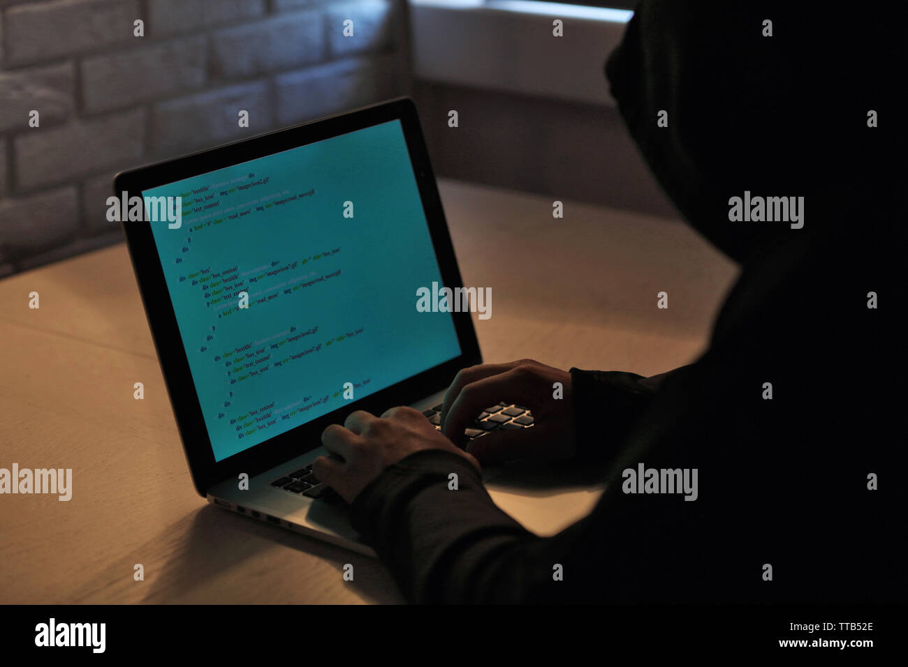 Hacker with laptop Stock Photo - Alamy