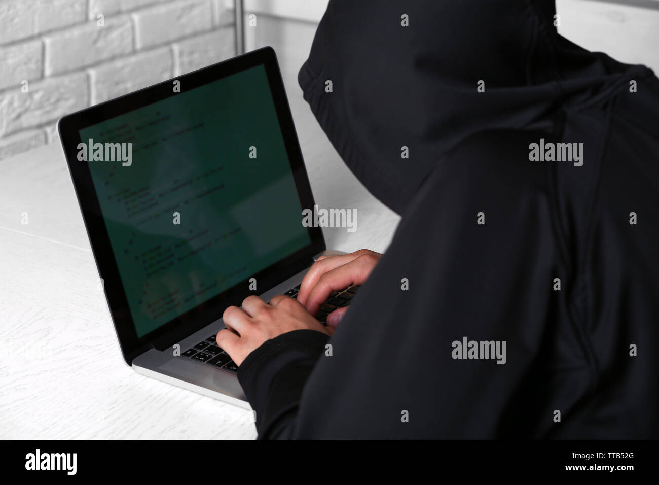 Hacker with laptop Stock Photo - Alamy
