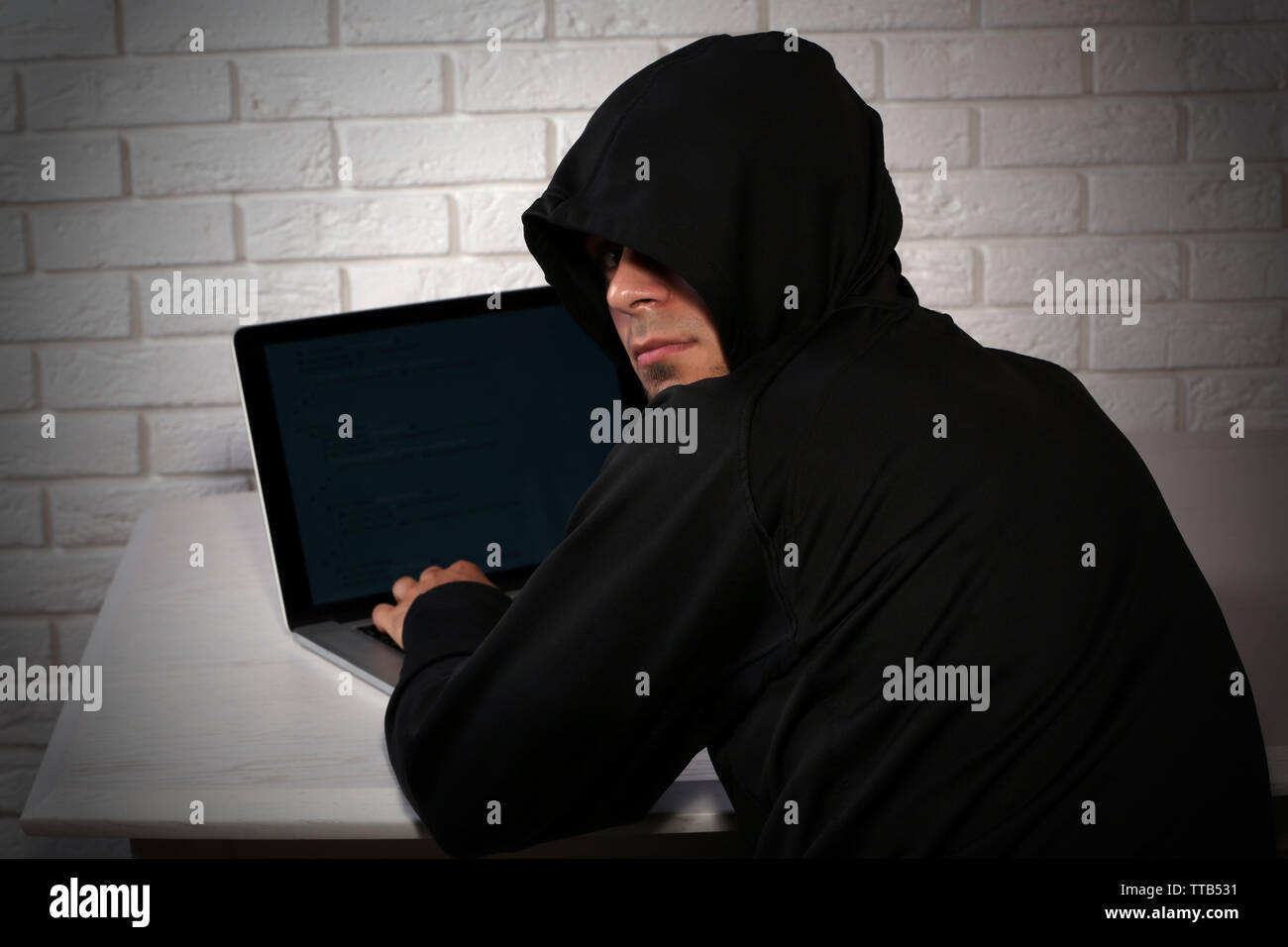 Hacker with laptop Stock Photo - Alamy