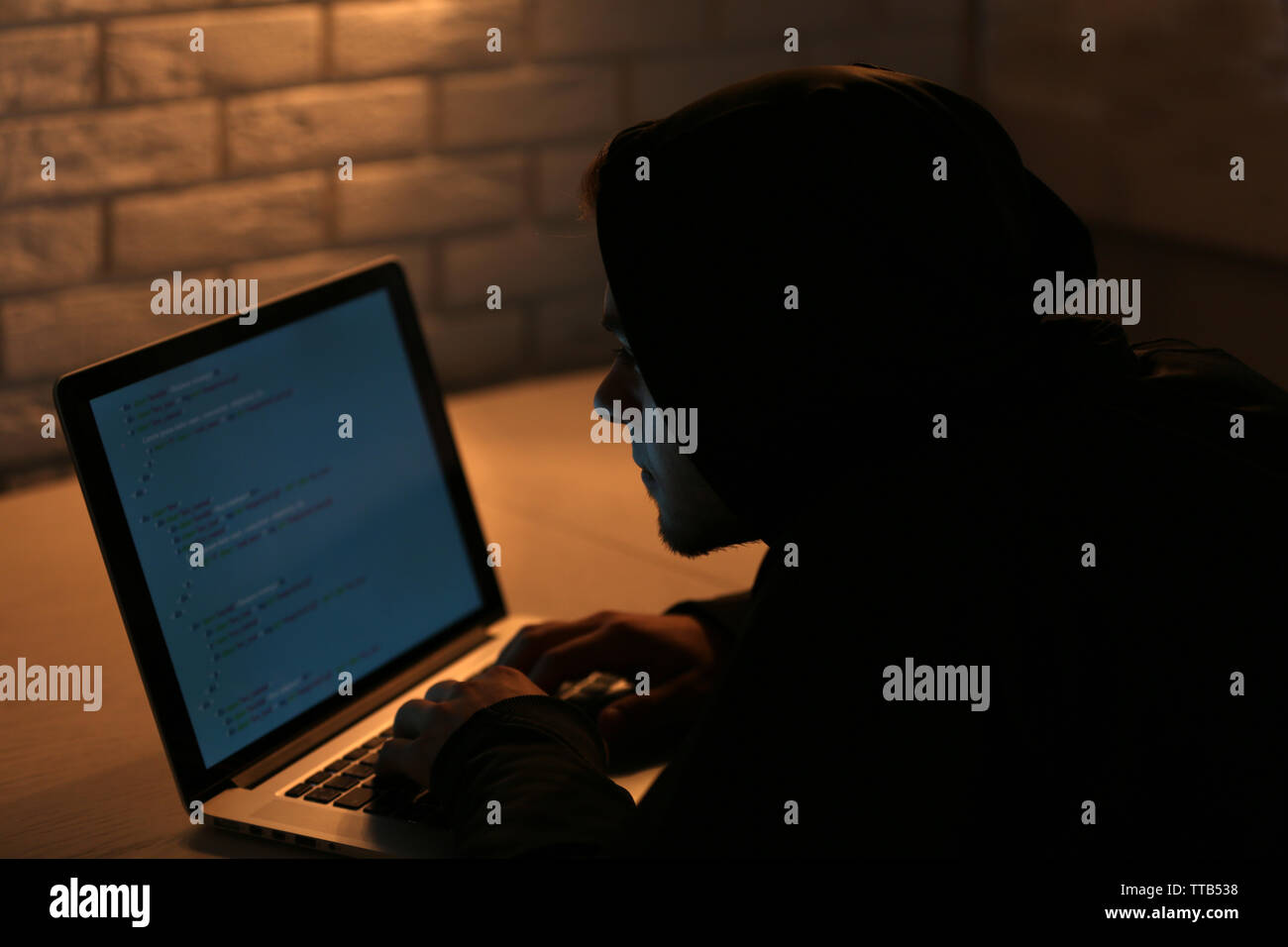 Hacker with laptop Stock Photo - Alamy