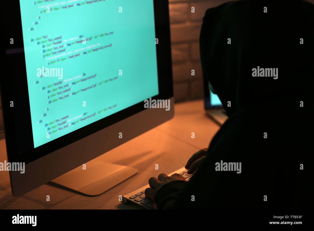 Hacker with computer and laptop Stock Photo - Alamy