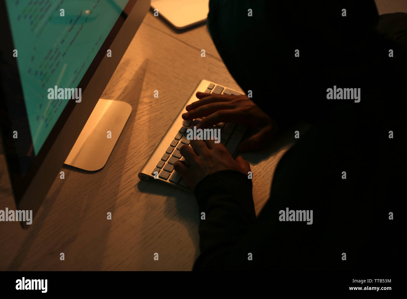 Hacker with computer and laptop Stock Photo - Alamy