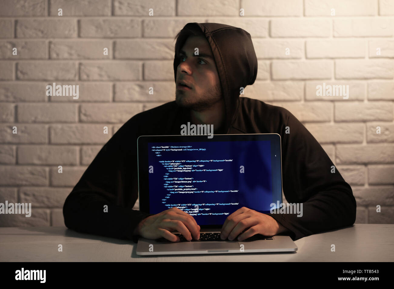 Hacker with laptop Stock Photo - Alamy