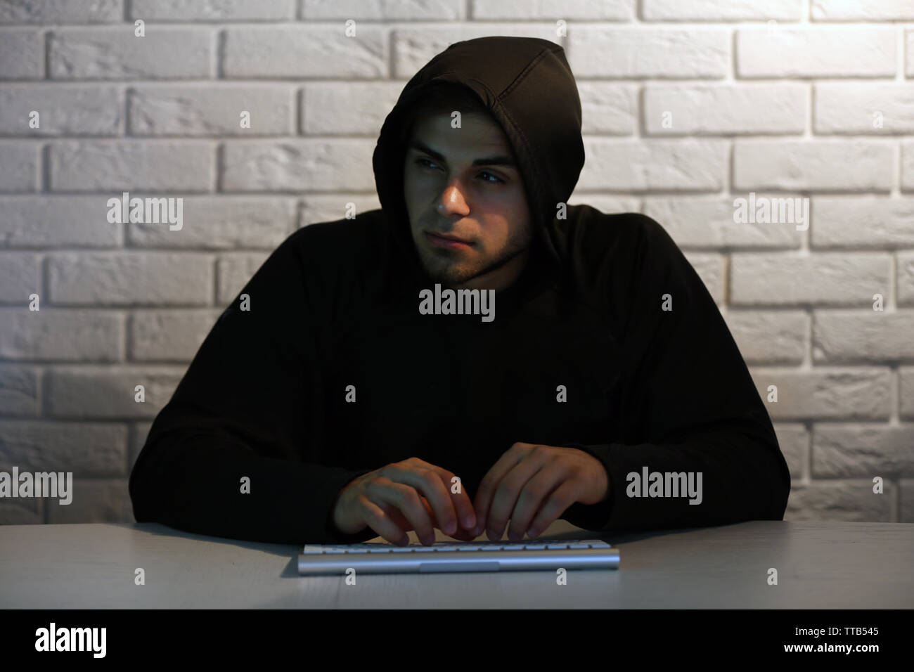 Hacker with laptop Stock Photo - Alamy